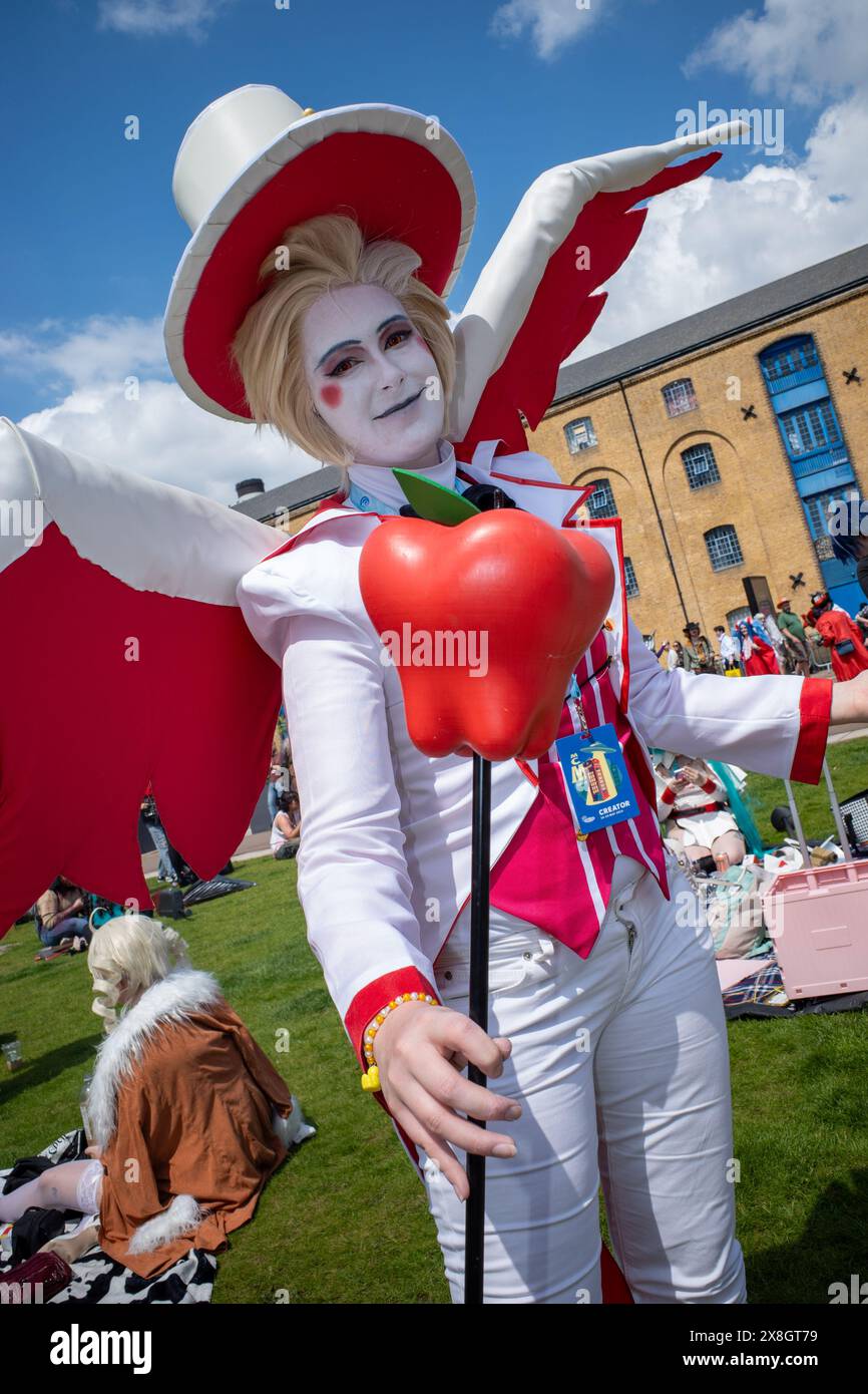 London, UK, 25th May, 2024. A Comic Con character holds an apple cane ...