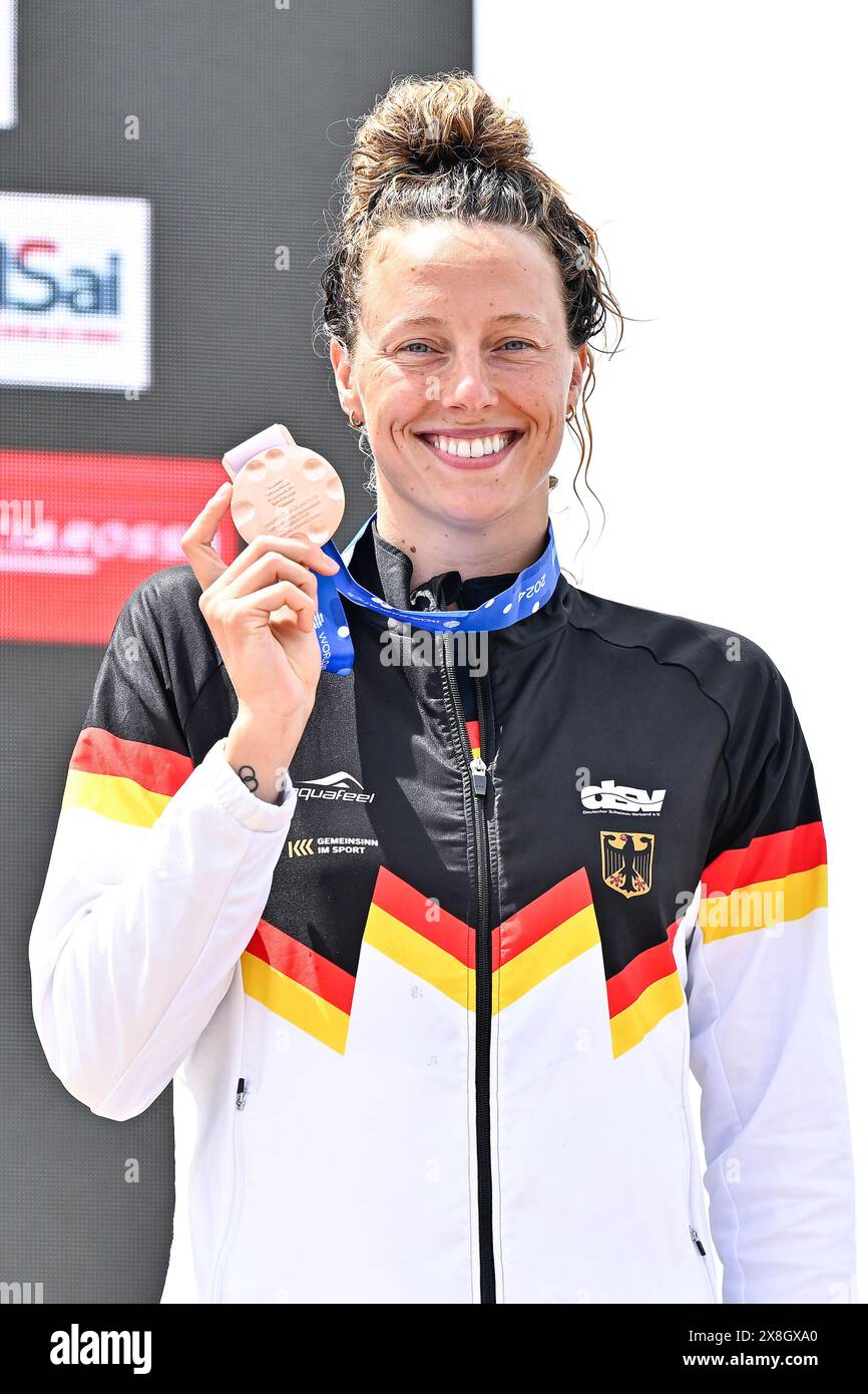 Leonie Beck of Germany shows the bronze medal after the Women's 10 km ...
