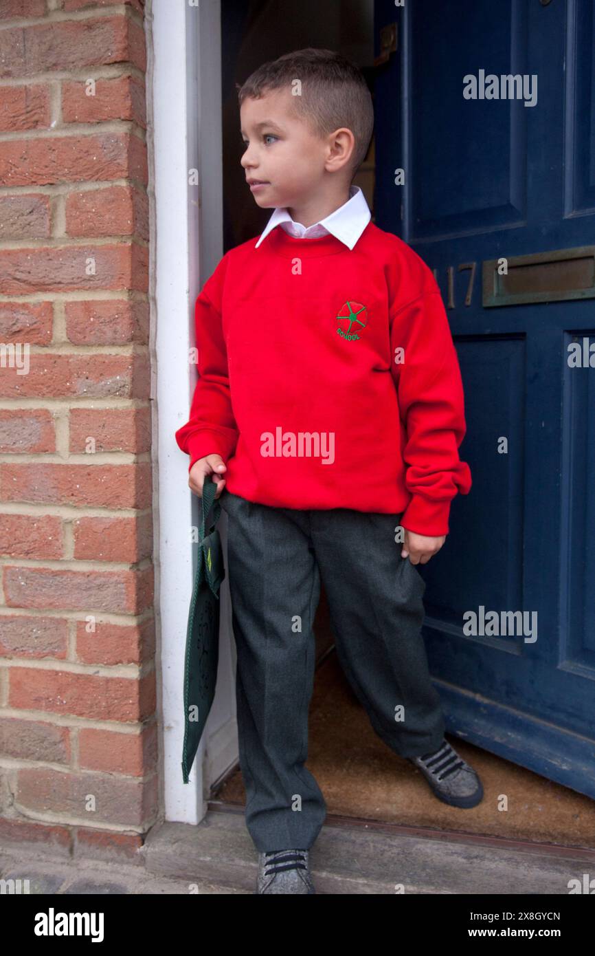 little boy in school uniform leaving house Stock Photo - Alamy