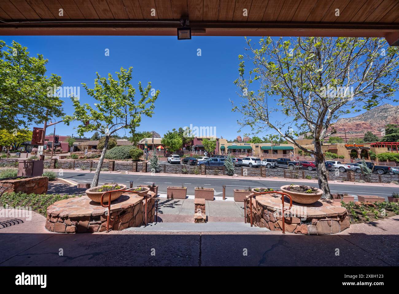 Shops and cars on State Highway 89A with red rock buttes in background ...