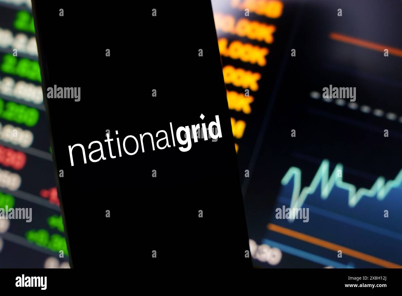 In this photo illustration, the National Grid logo is displayed on a ...
