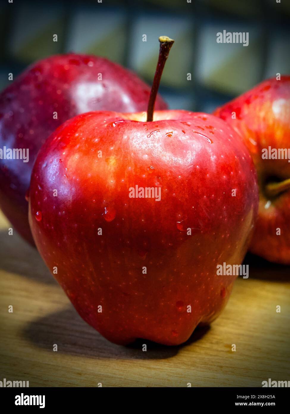 Glossy Apples: Apples with a shiny finish against a dark patterned ...