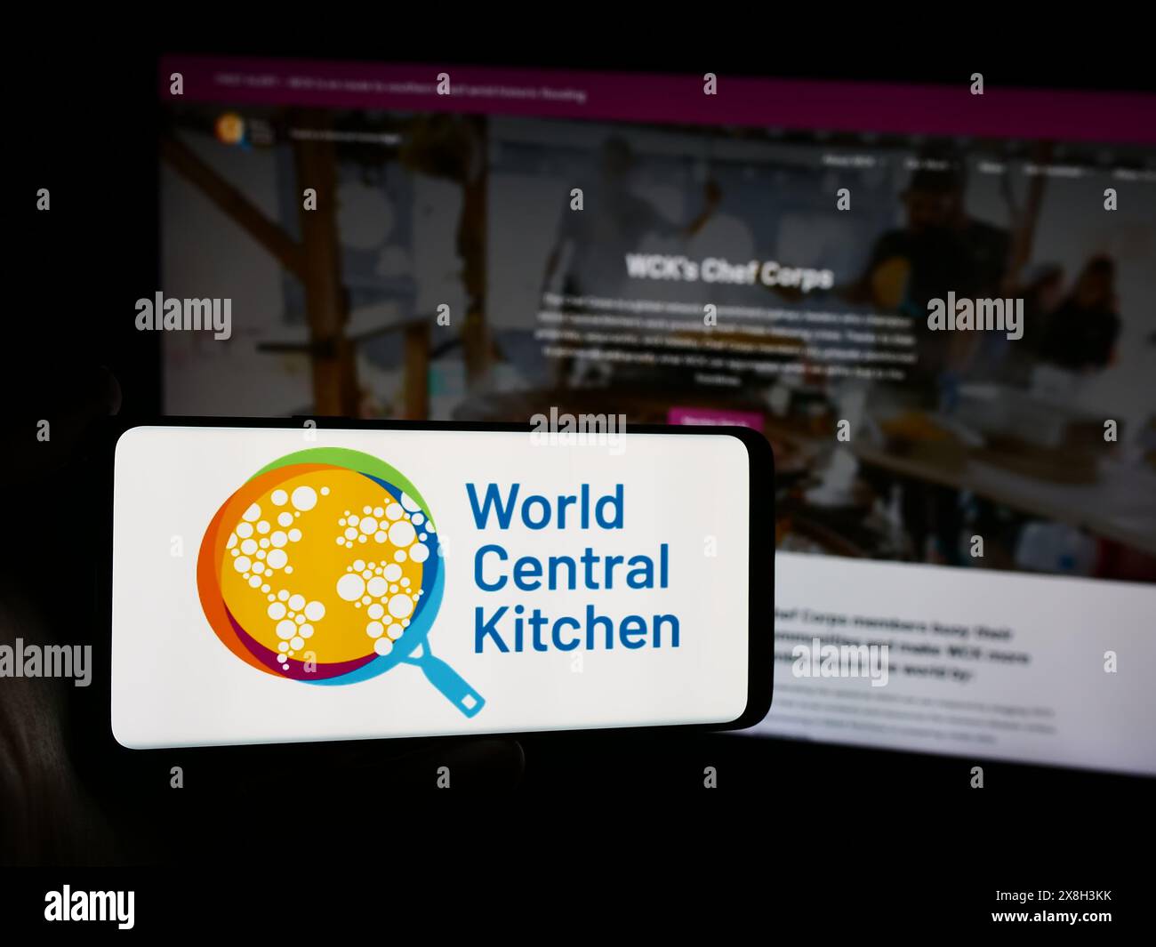 Person holding mobile phone with logo of food relief organisation World ...