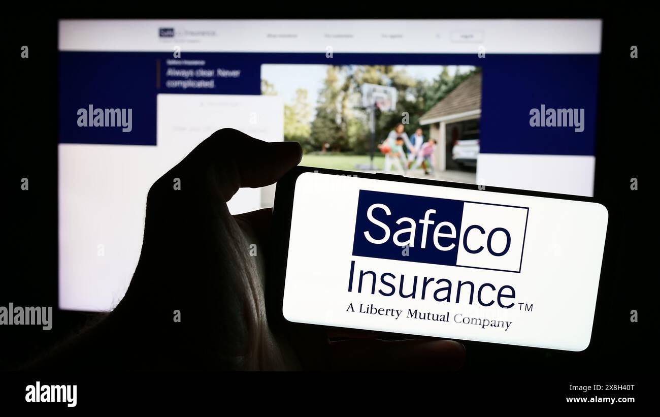 Person holding mobile phone with logo of American financial services ...