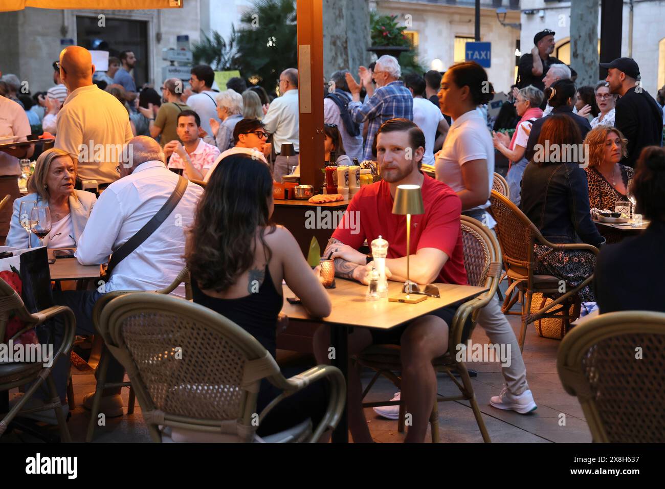 Several people on a terrace during a demonstration against tourist ...
