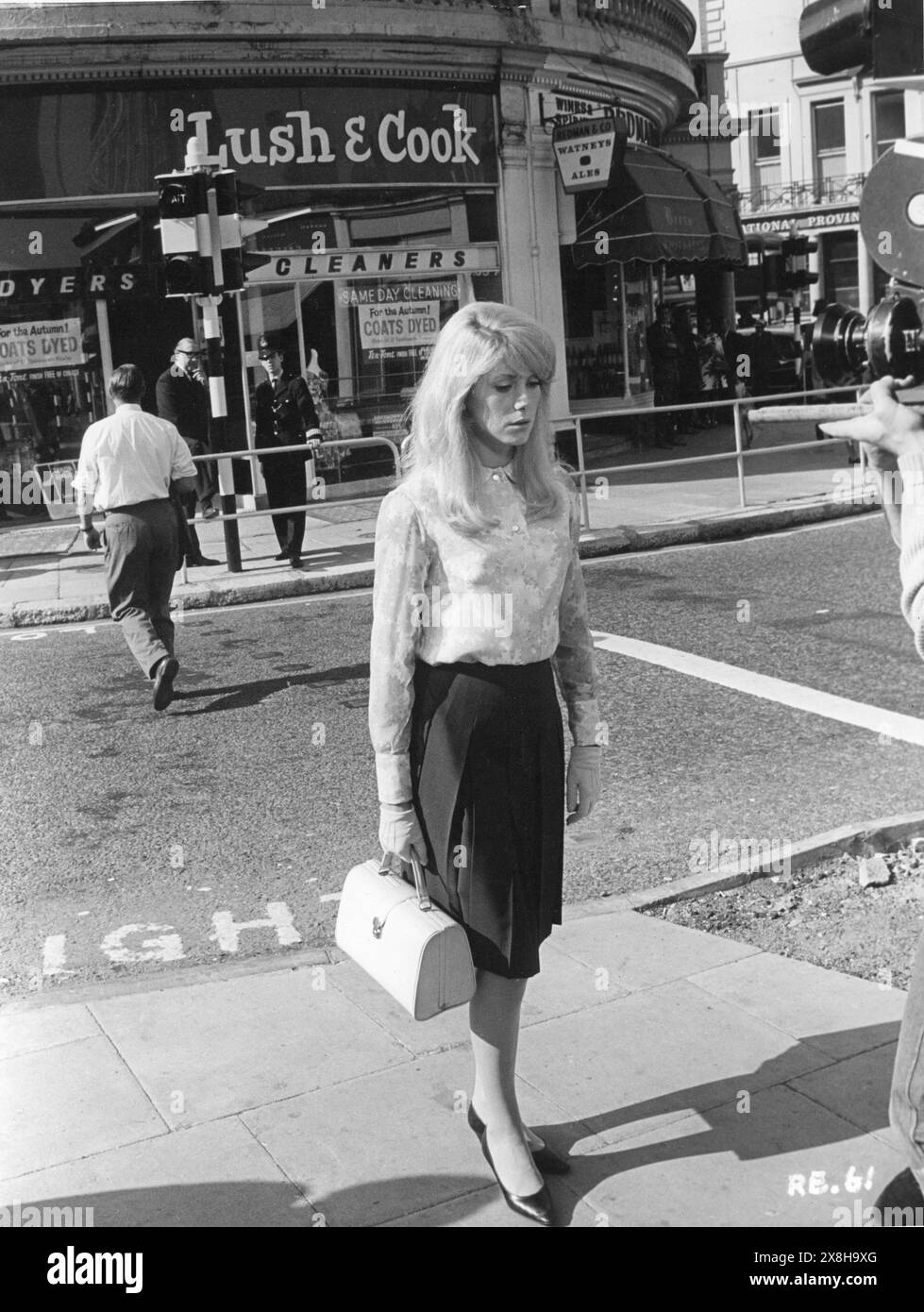 French actress CATHERINE DENEUVE filming a scene on location in London ...