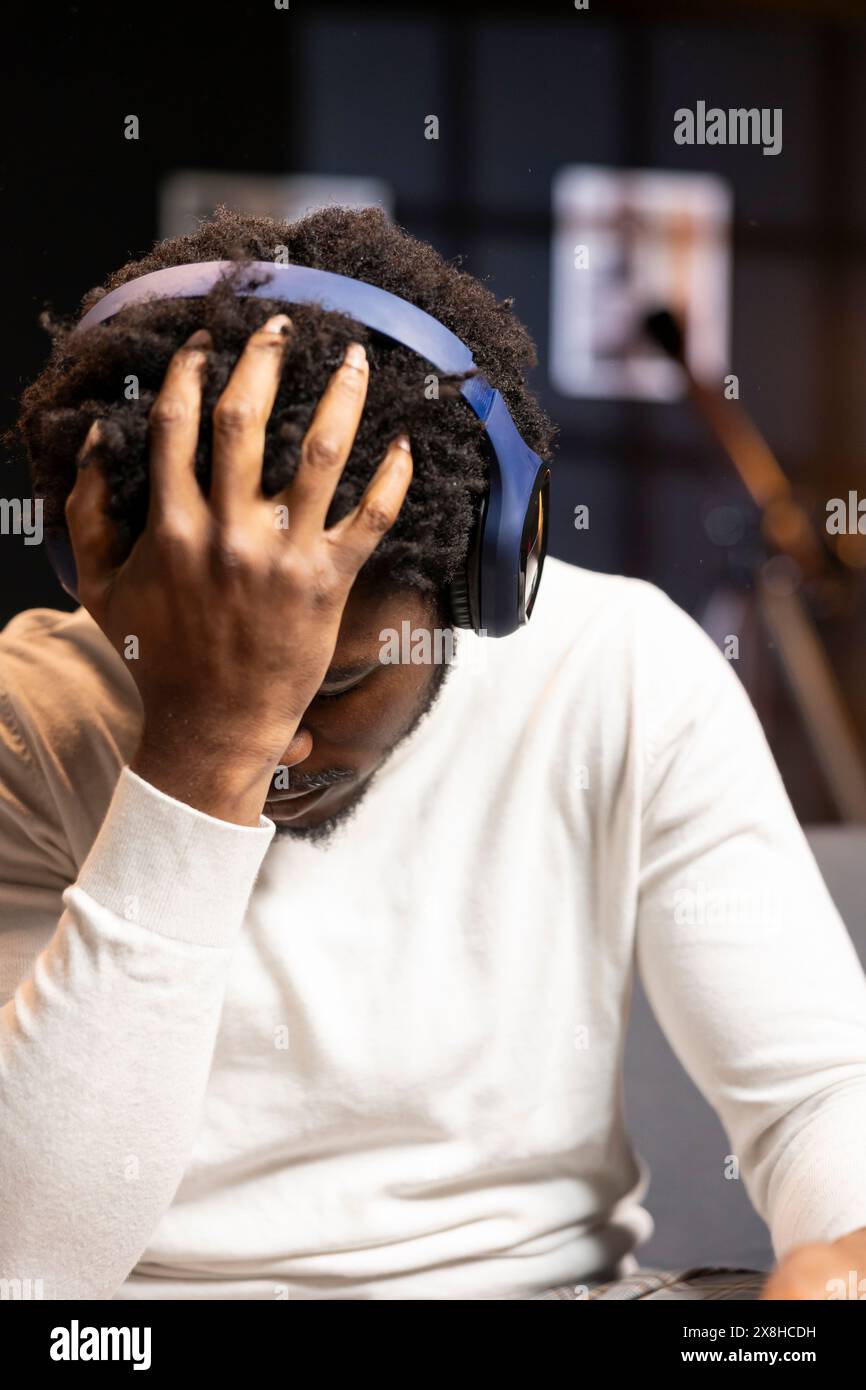 Gamer wearing headphones face palming himself in frustration after ...