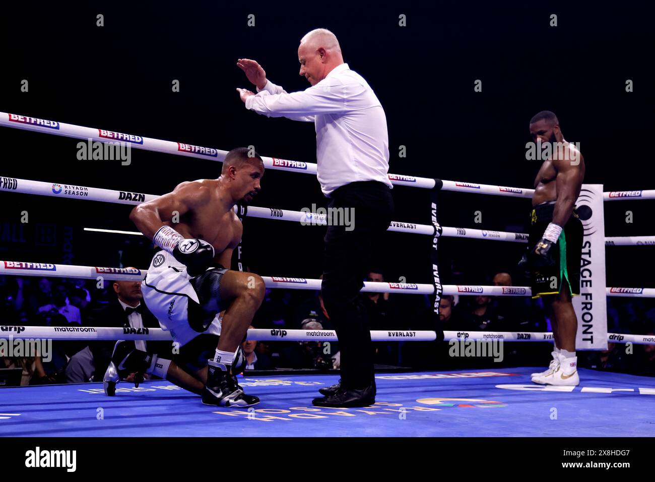 The referee stops the fight after Ellis Zorro (left) is knocked down by ...