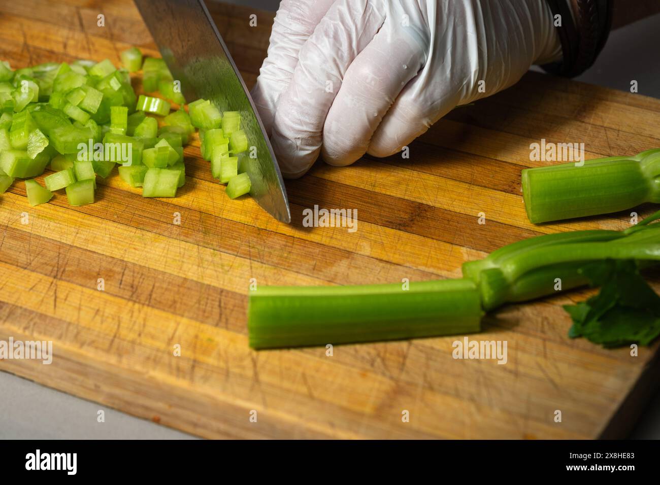Chef dicing celery with a cook's knife. Studio shot Stock Photo - Alamy