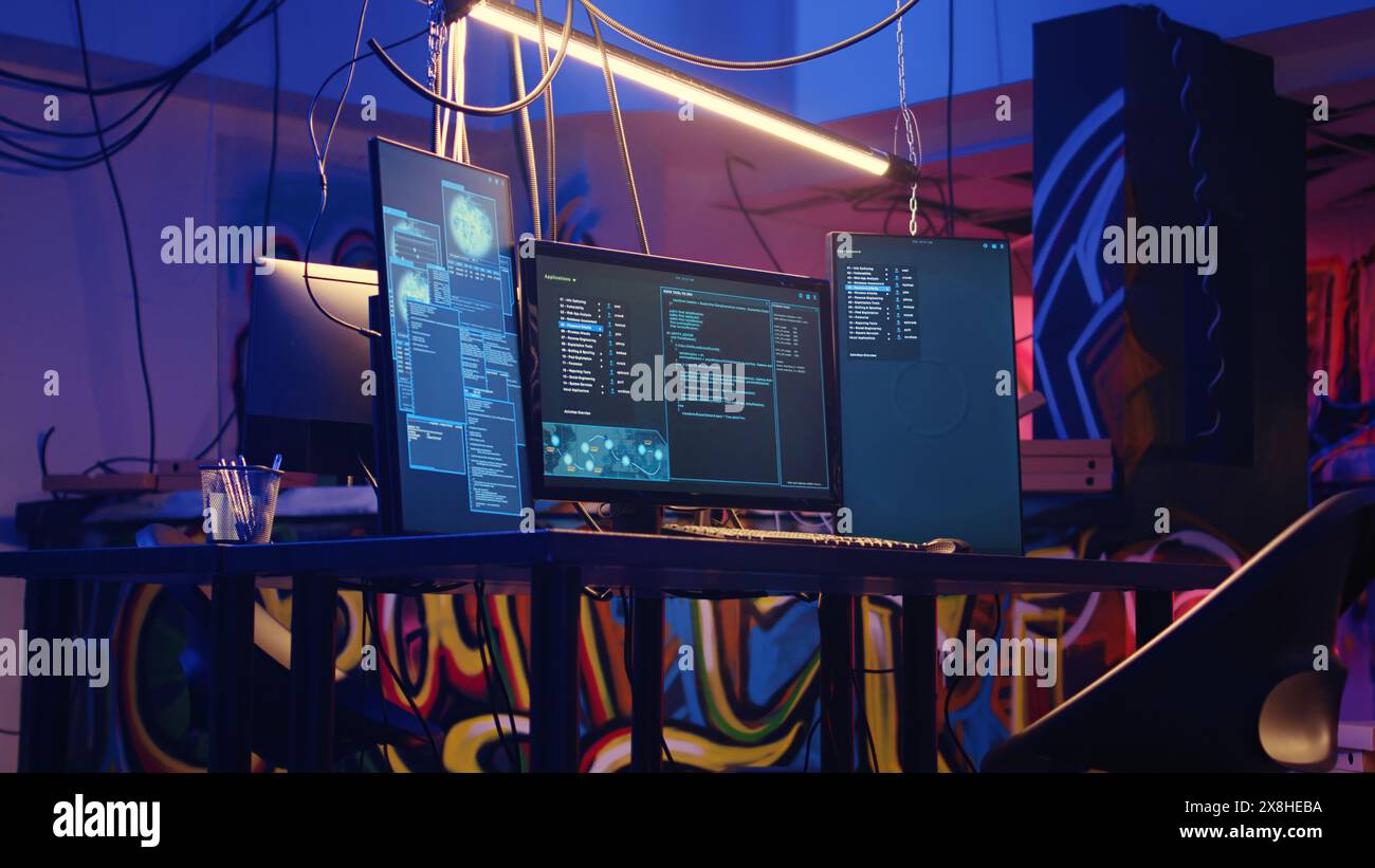 Jib down shot of abandoned basement with graffiti drawings on walls and high tech computer ...