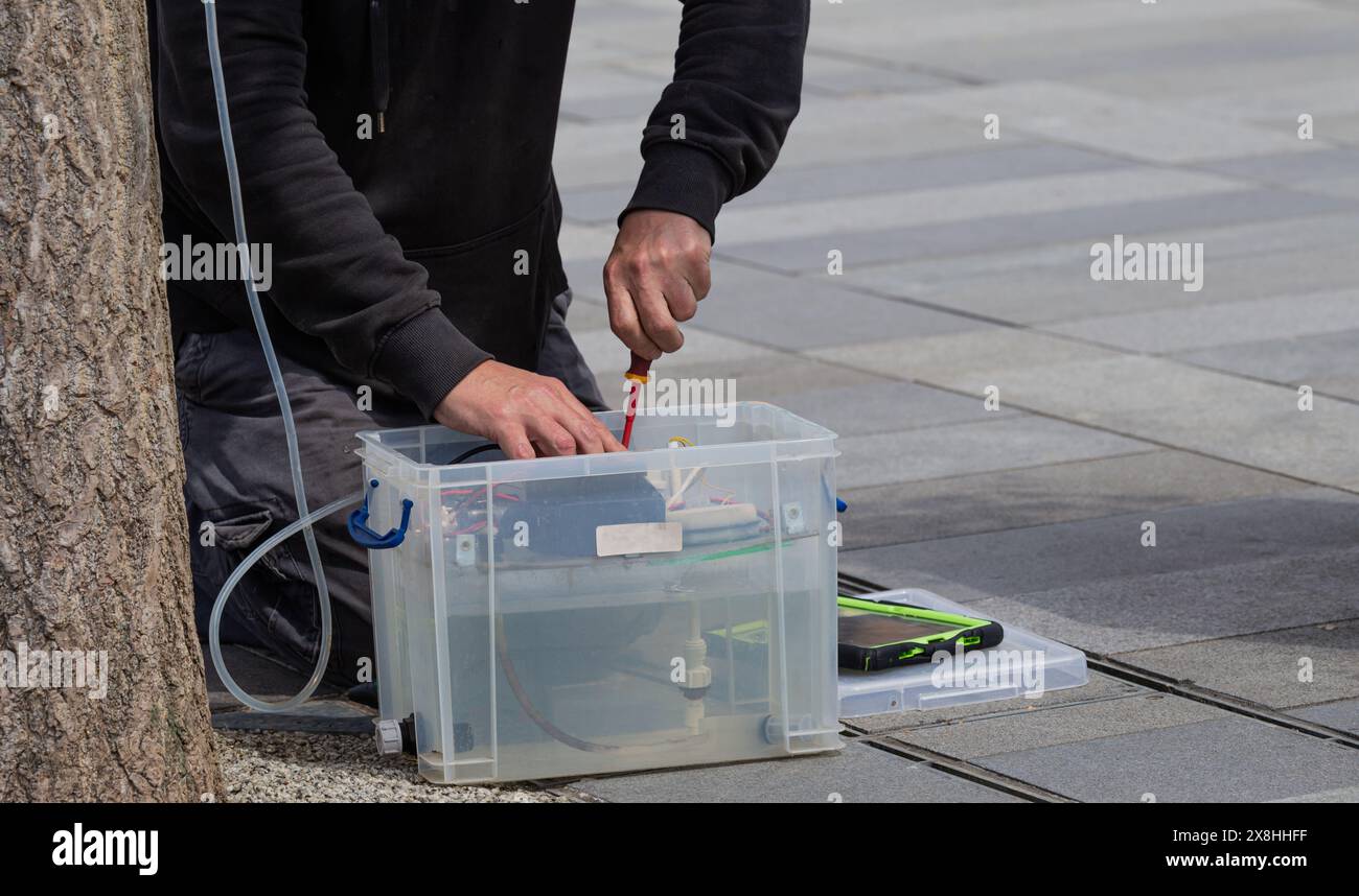 Human Hands Holding a Tool and Supporting an Electric Pump in a Clear ...