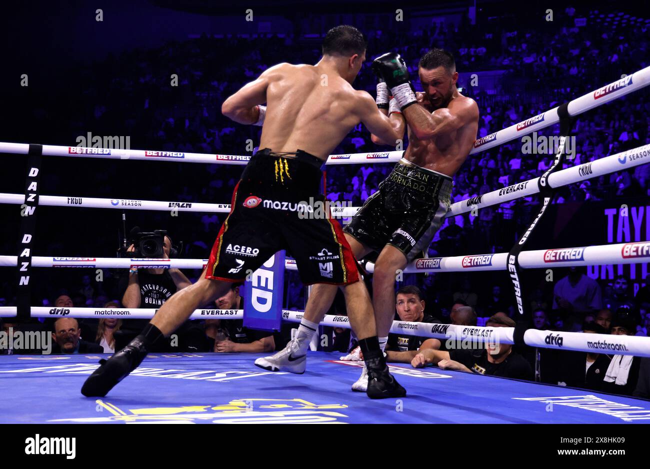 Jack Catterall (left) strikes Josh Taylor in the super lightweight bout ...