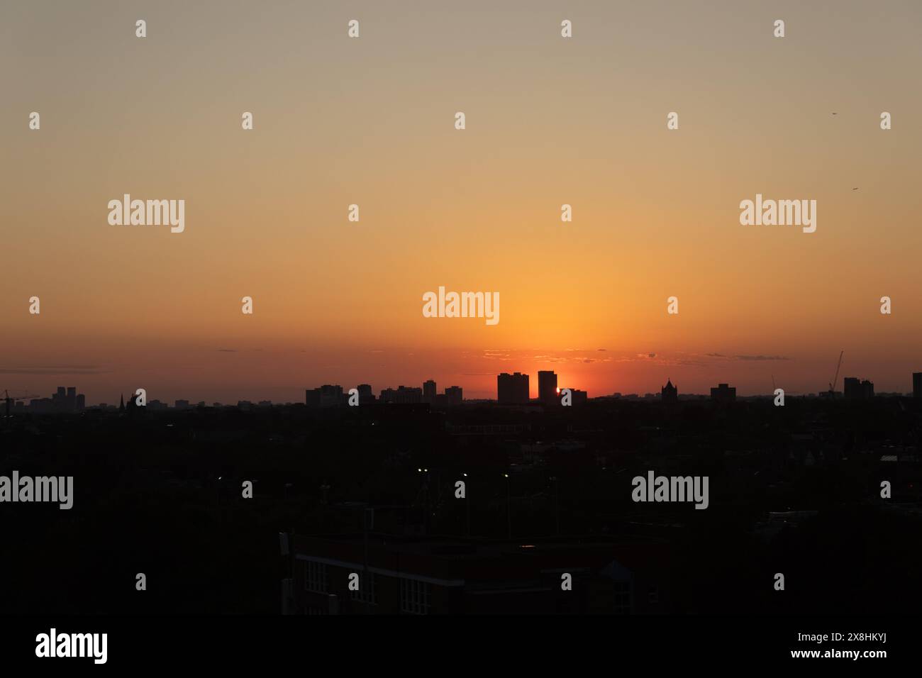 Orange sunset - city skyline silhouette - buildings dark outlines ...