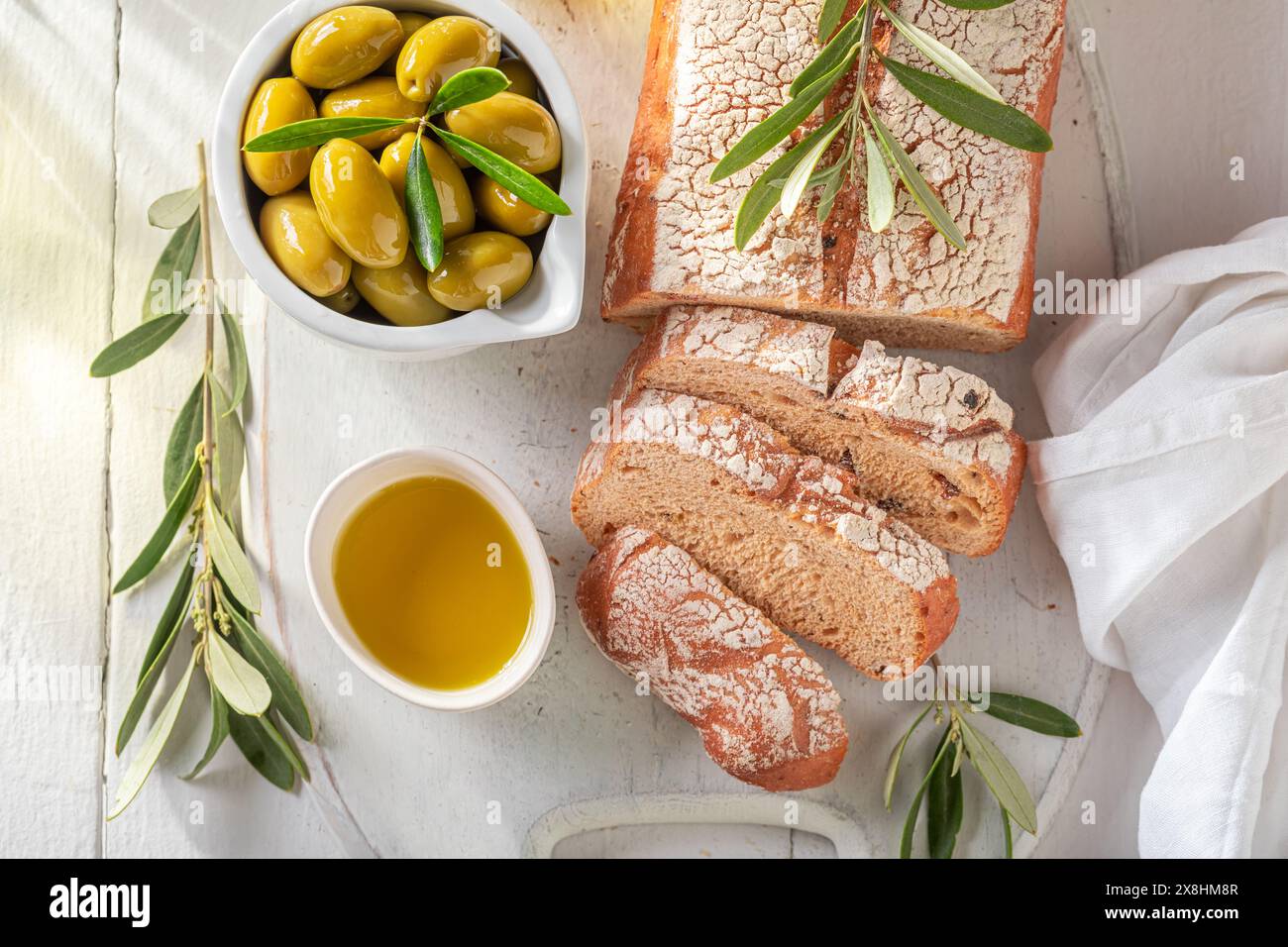 Tasty bread with extra virgin olive oil. Loaf of bread with green ...
