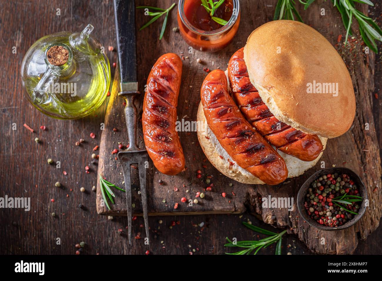 Spicy grilled sausage with bun made on bonfire grill. Grilled sausage ...