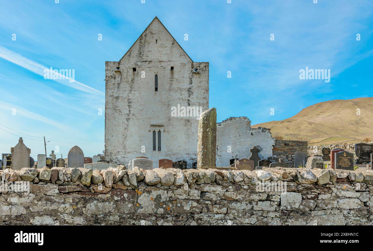 Ancient derelict church building against a blue sky surrounded by ...