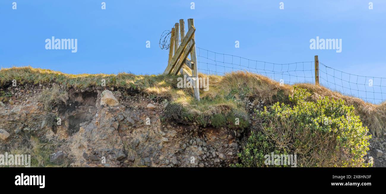 Fence on the top of a cliff face against a clear blue sky Stock Photo ...