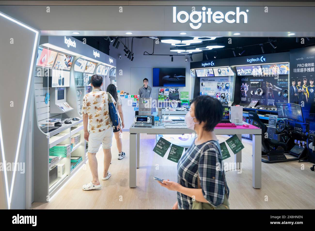 Customers are seen at the Swiss electronics company Logitech store in ...