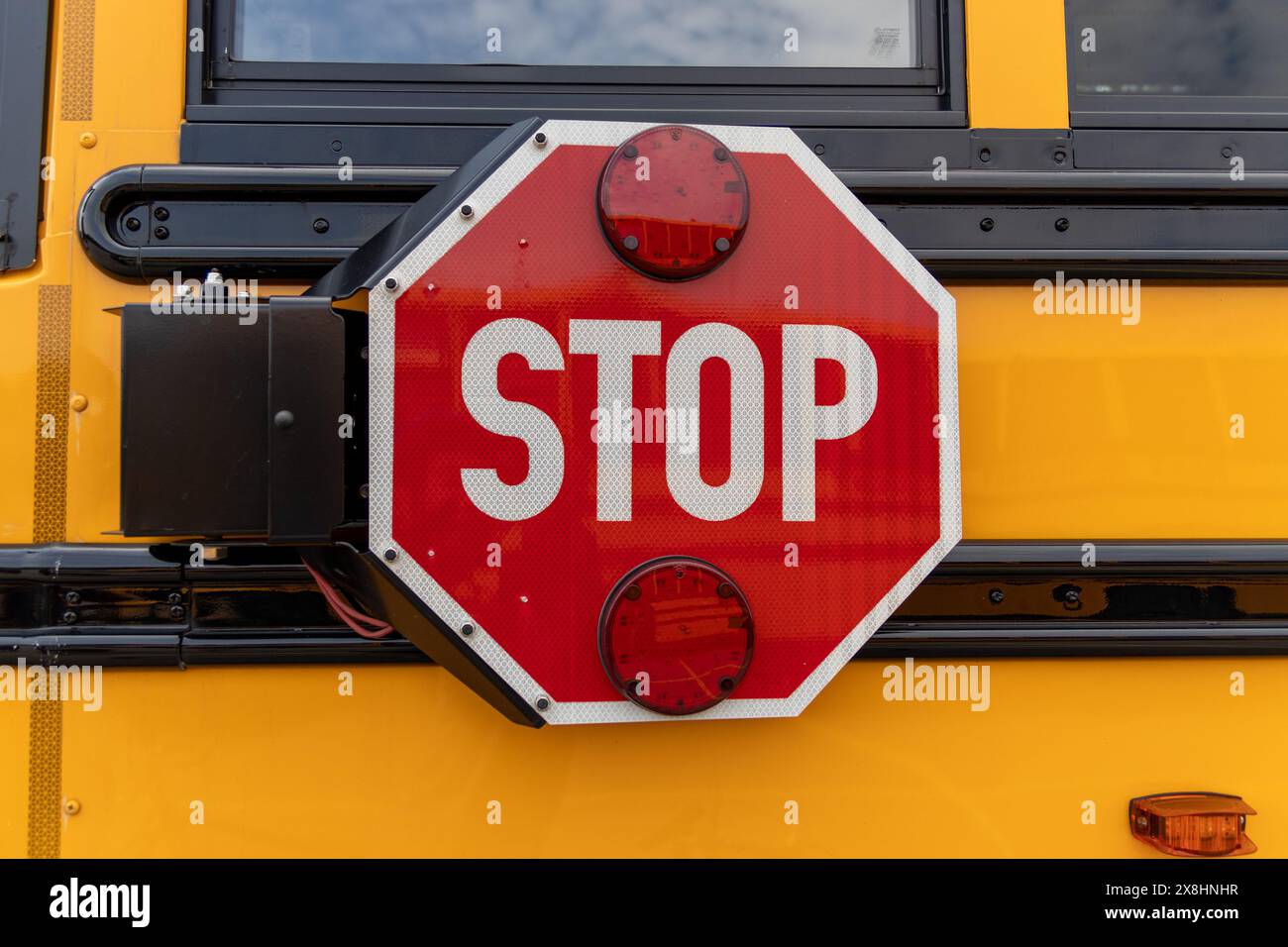 Close-up view of red and white STOP sign - yellow school bus - clear ...