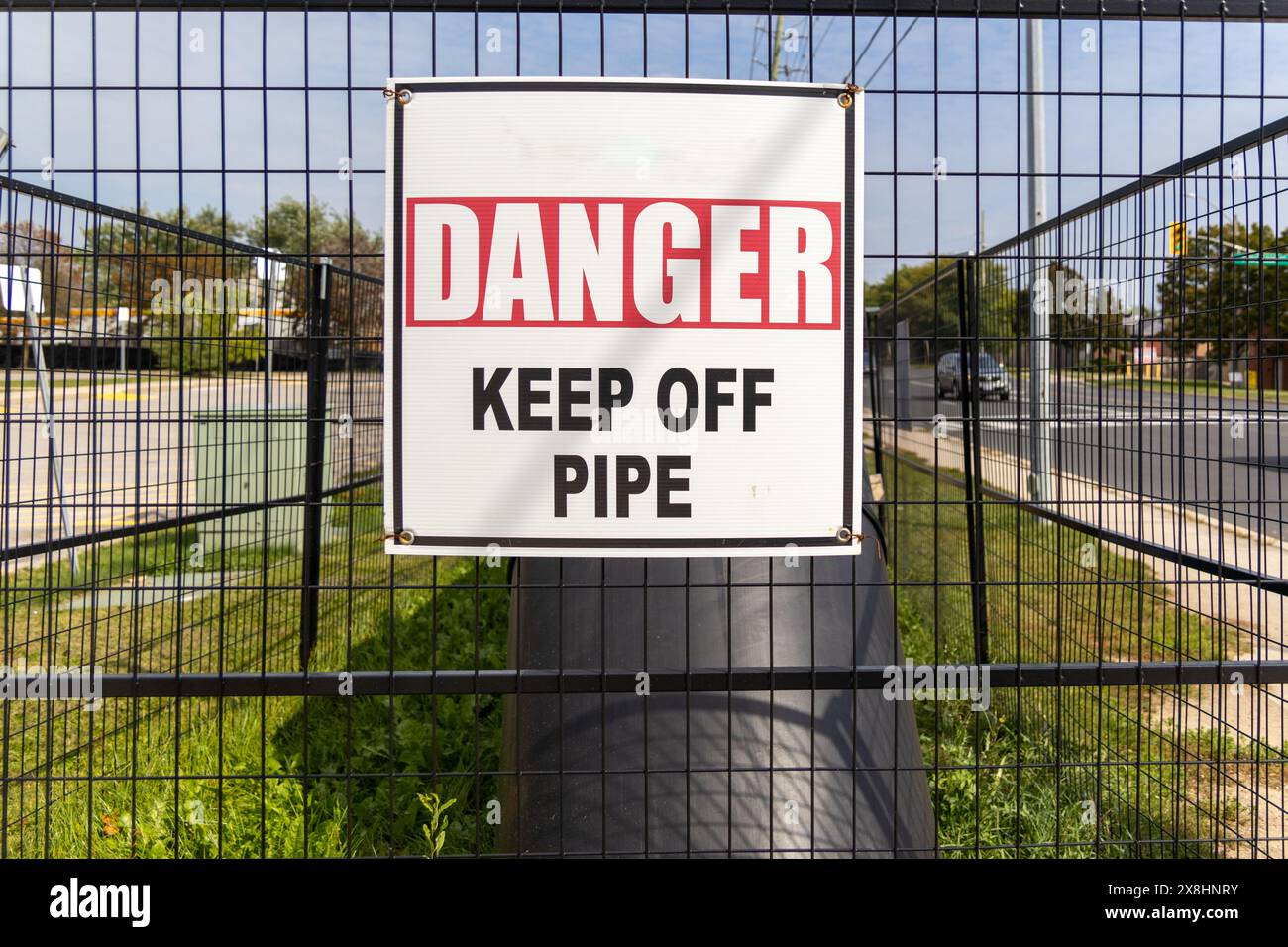 White rectangular warning sign - bold red letters stating DANGER KEEP ...