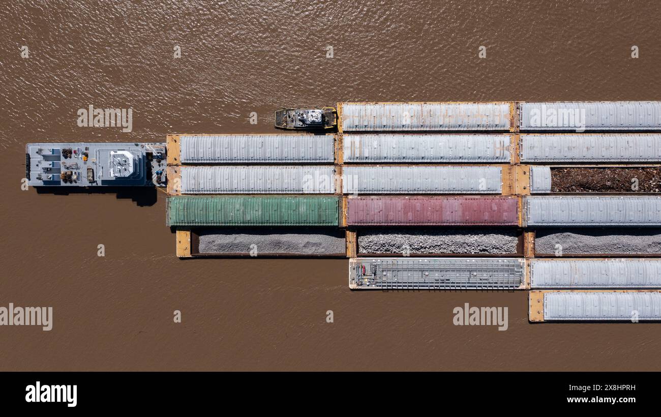 A towboat, known as a pusher, pushes barges full of cargo up the ...