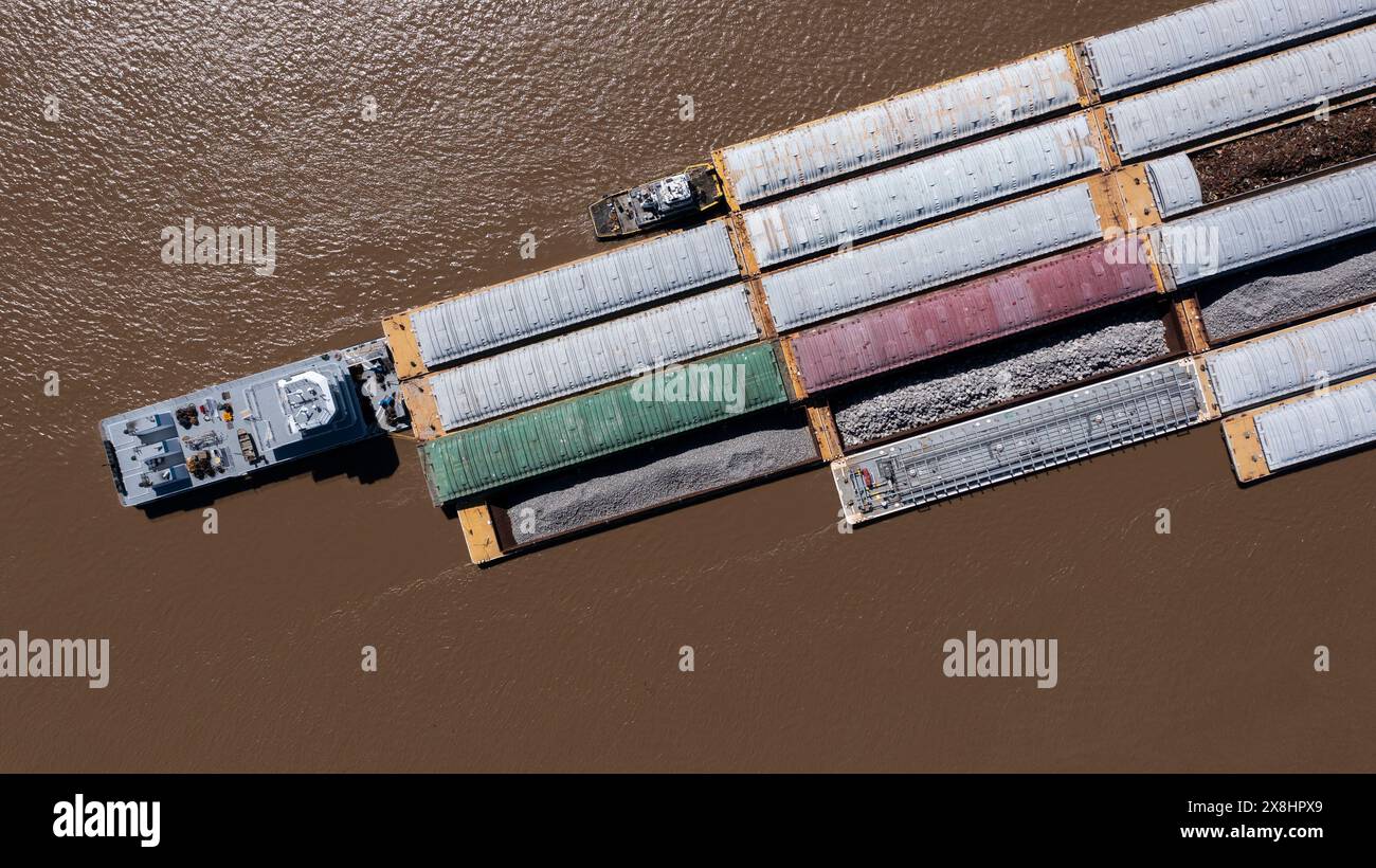 A towboat, known as a pusher, pushes barges full of cargo up the ...