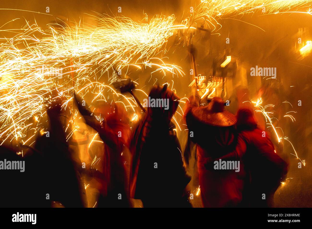 Barcelona, Spain. 25 May, 2024: Fire runners dance to traditional drums ...