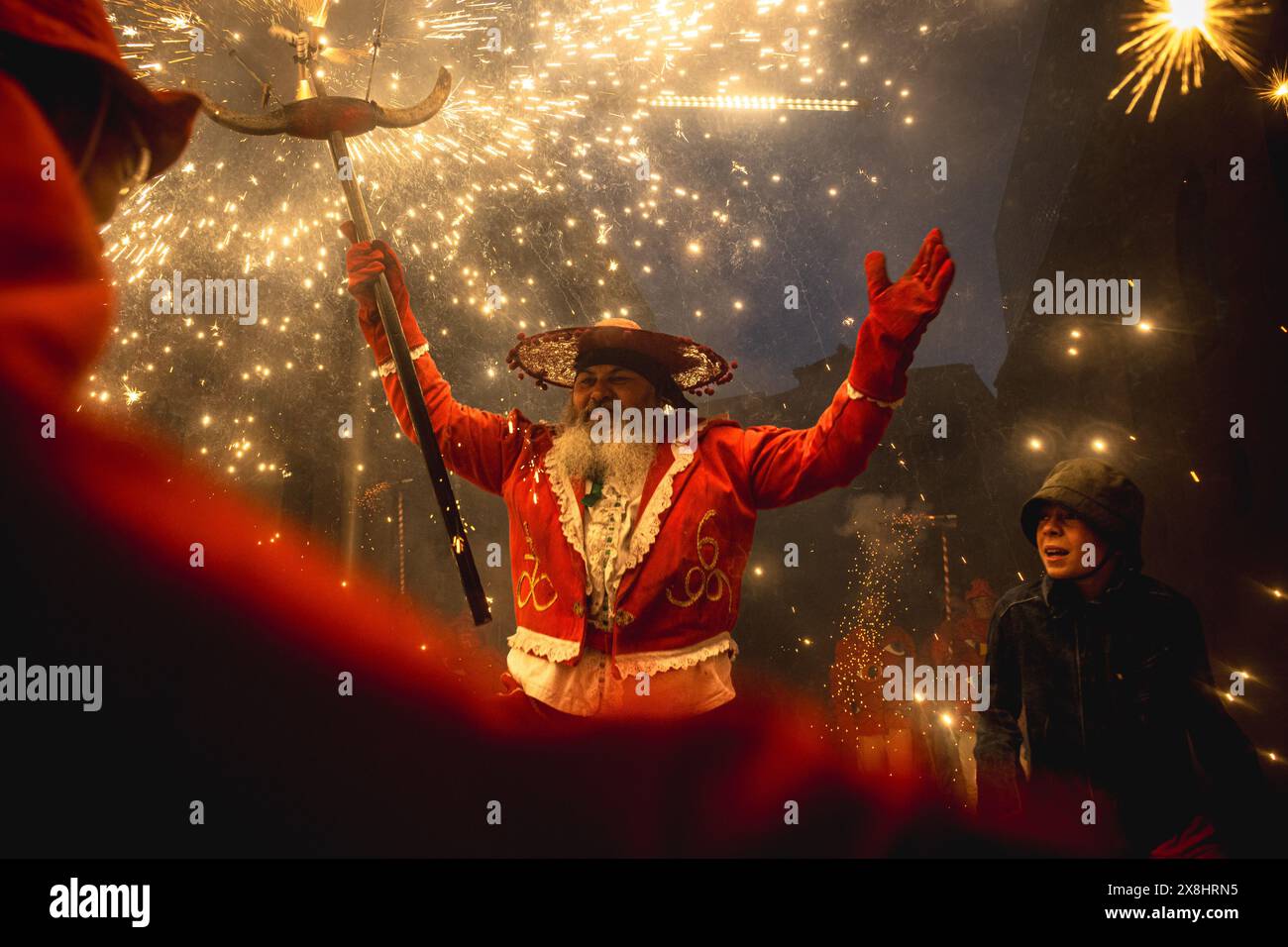 Barcelona, Spain. 25th May, 2024. A fire runner dances to traditional ...
