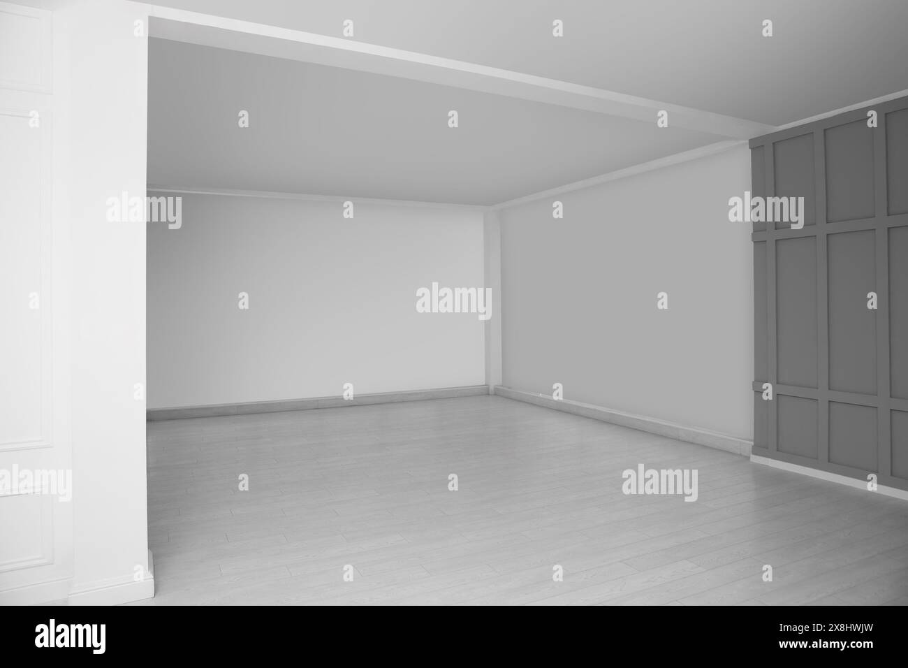 Empty room with grey wall and laminated floor Stock Photo - Alamy