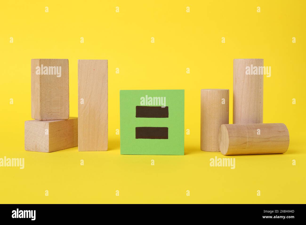 Wooden blocks and equals sign on yellow background Stock Photo - Alamy