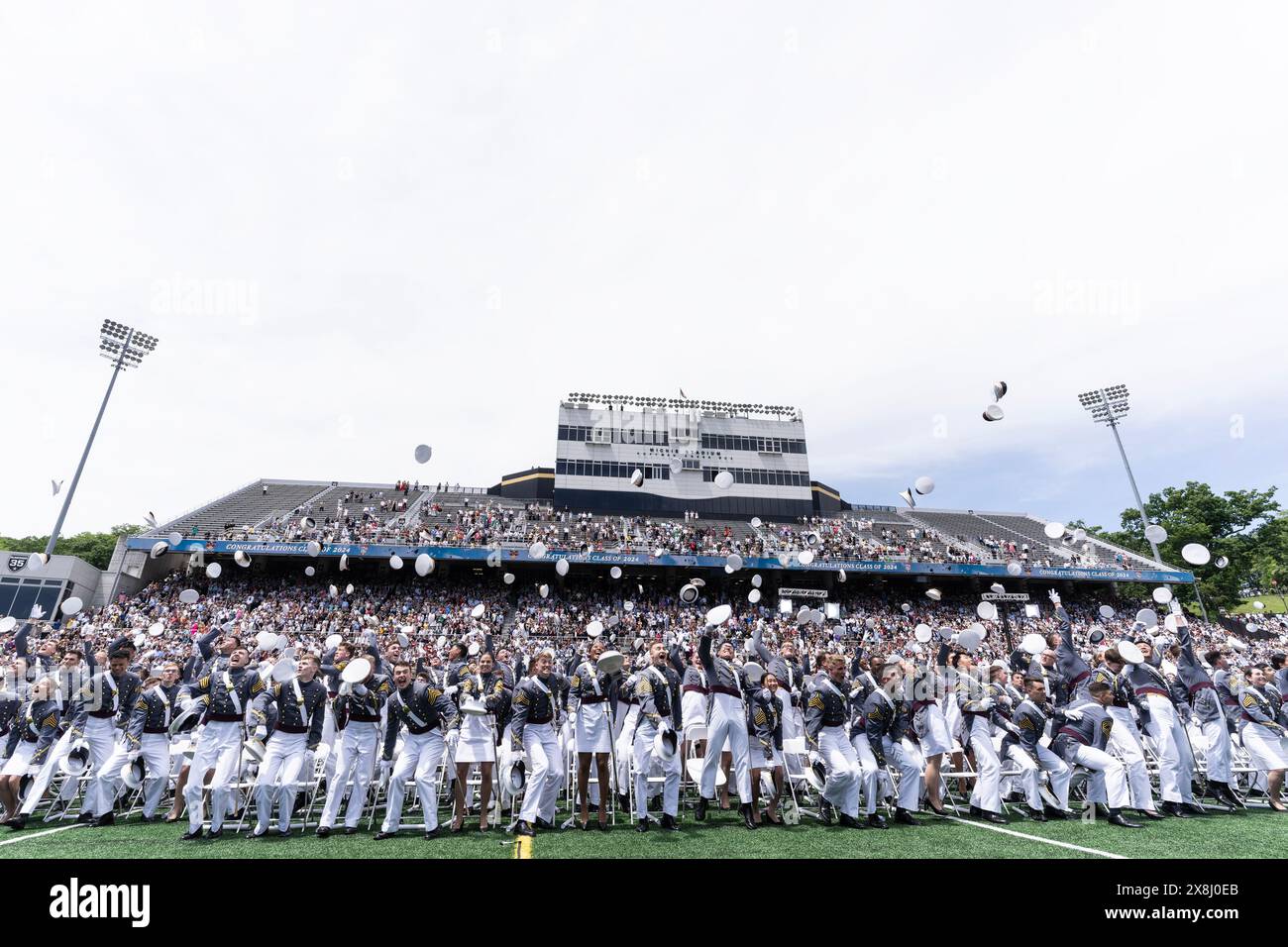 Graduates toss their hat as tradition after receiving diplomas during U ...