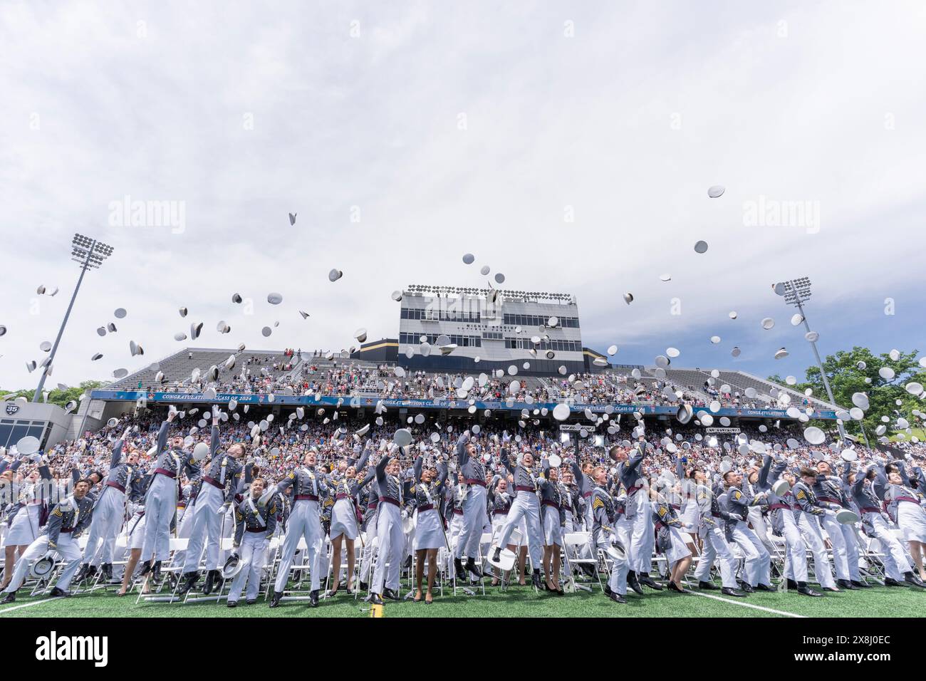 Graduates toss their hat as tradition after receiving diplomas during U ...