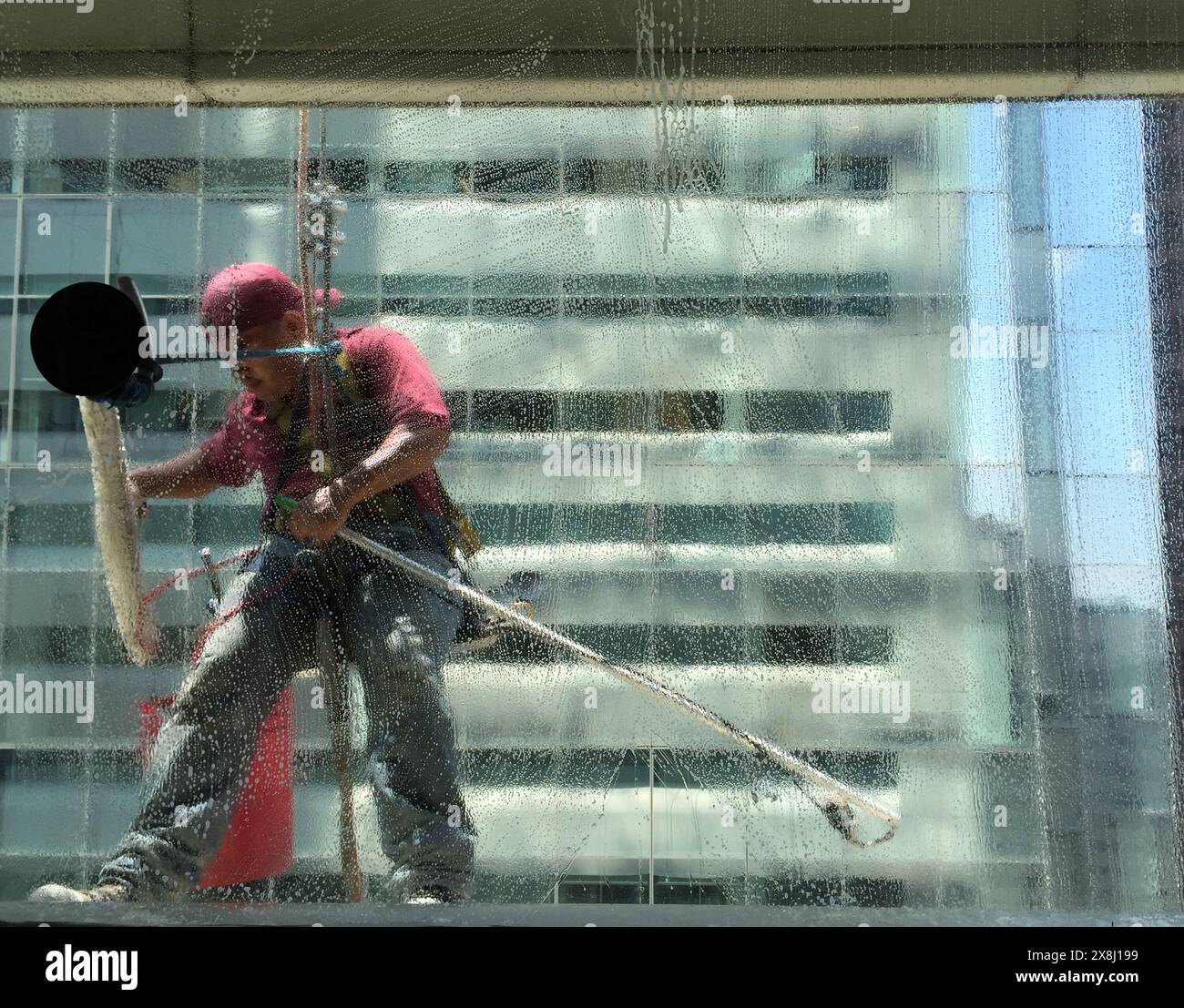 A window washer cleans a high-rise building at 17th and Arch streets in ...