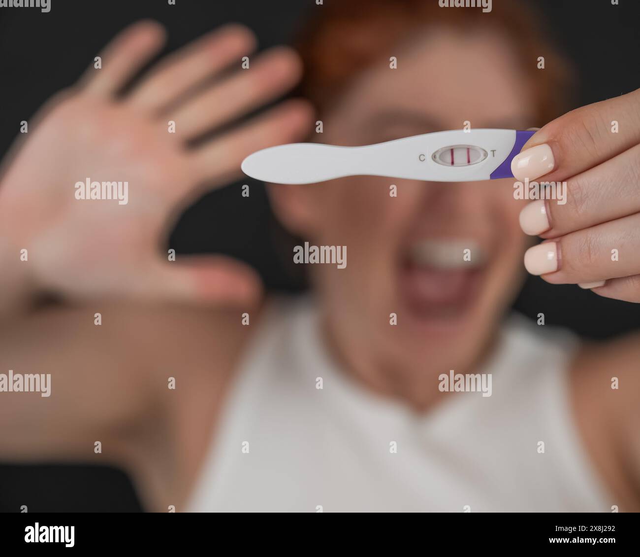 Blurred portrait of upset caucasian woman holding positive rapid ... Blurred portrait of upset caucasian woman holding positive rapid ...