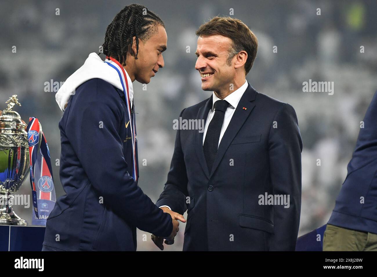 French President Emmanuel Macron shakes hand with Paris Saint-Germain's ...