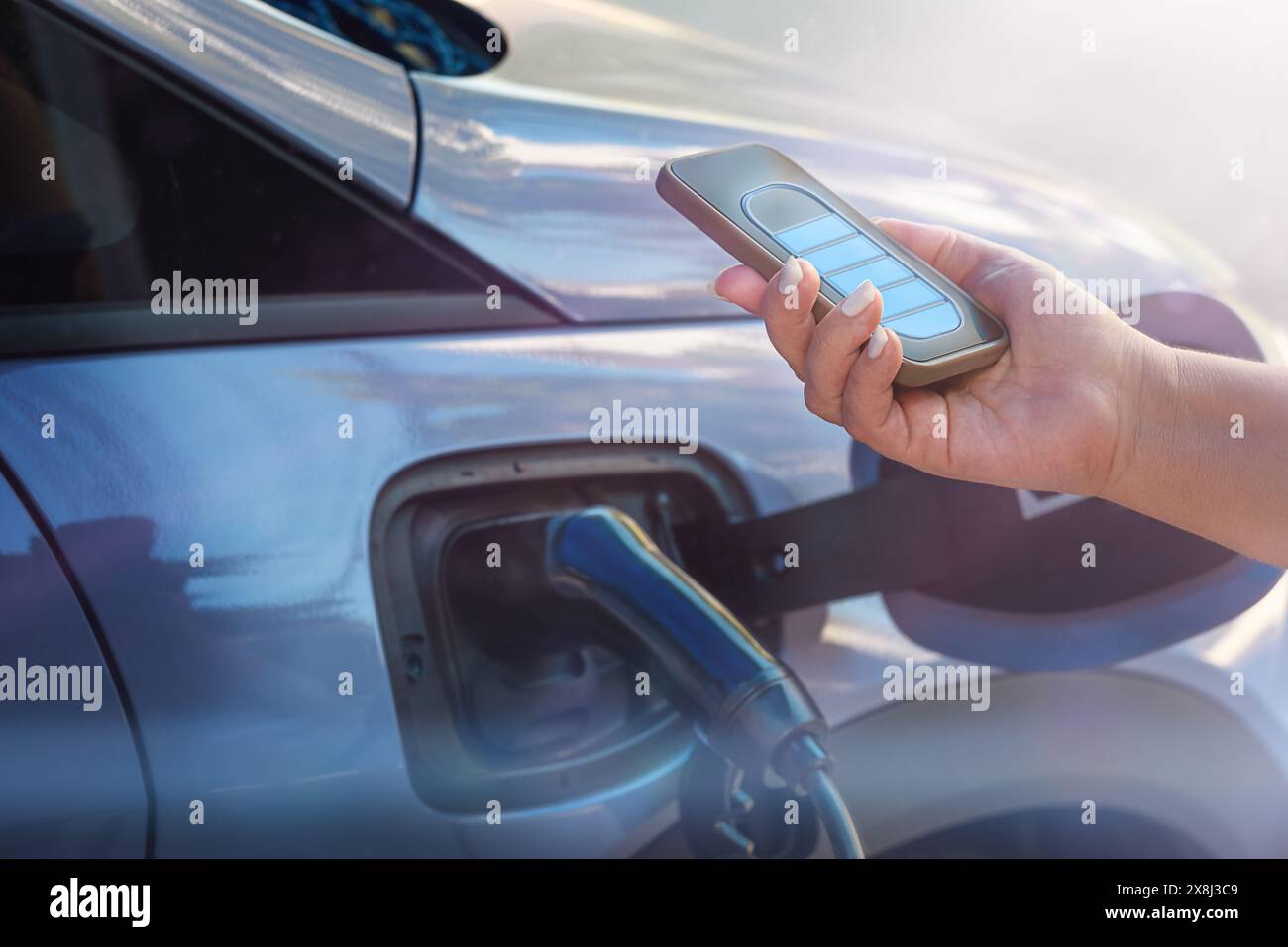 Woman hand holding phone EV charging for car outdoors Stock Photo - Alamy Woman hand holding phone EV charging for car outdoors Stock Photo - Alamy