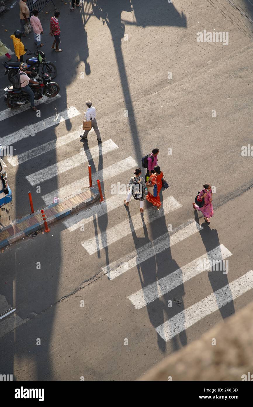 Pedestrians crossing road via zebra crossing or crosswalk. Shyambazar ...