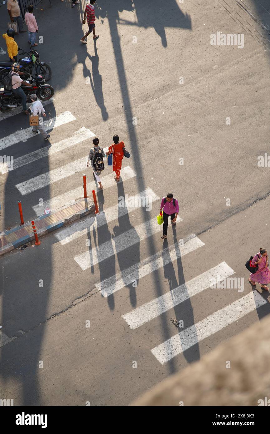 Pedestrians crossing road via zebra crossing or crosswalk. Shyambazar ...
