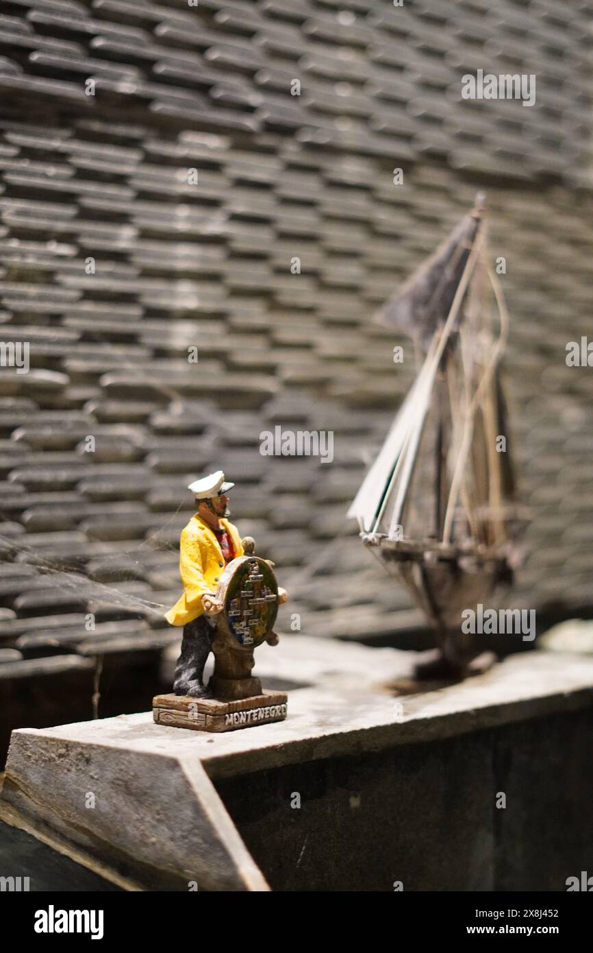 The figure of a sailor holding the steering wheel of a ship with the ...