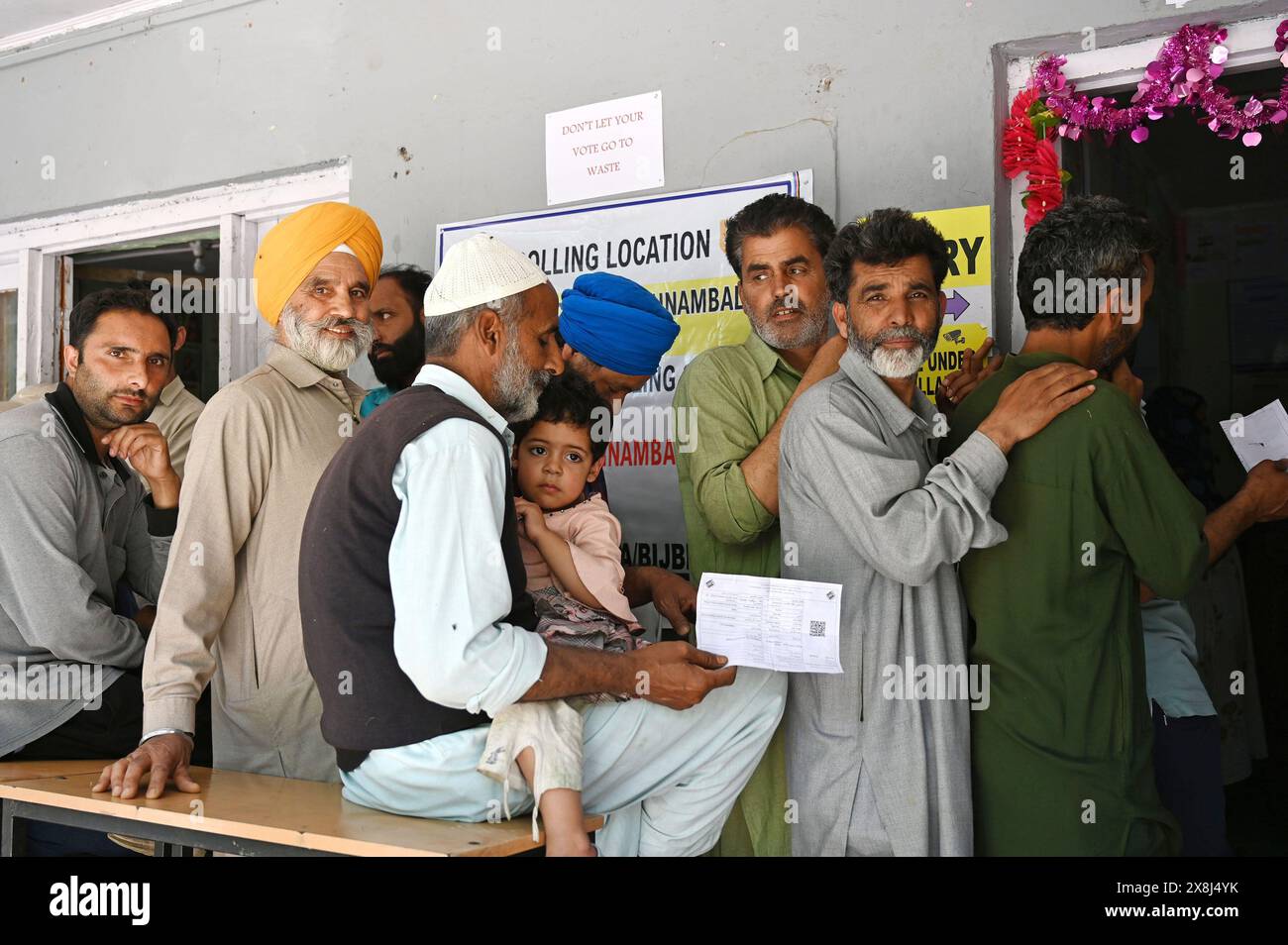 SRINAGAR, INDIA - MAY 25: People stand in queue to cast their votes ...