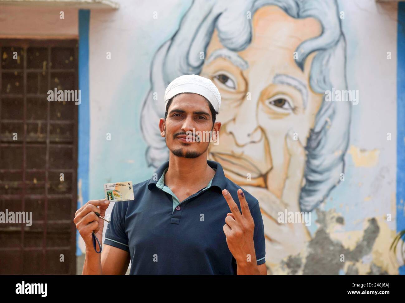 GURUGRAM, INDIA - MAY 25: A boy poses for a picture in front of a mural ...