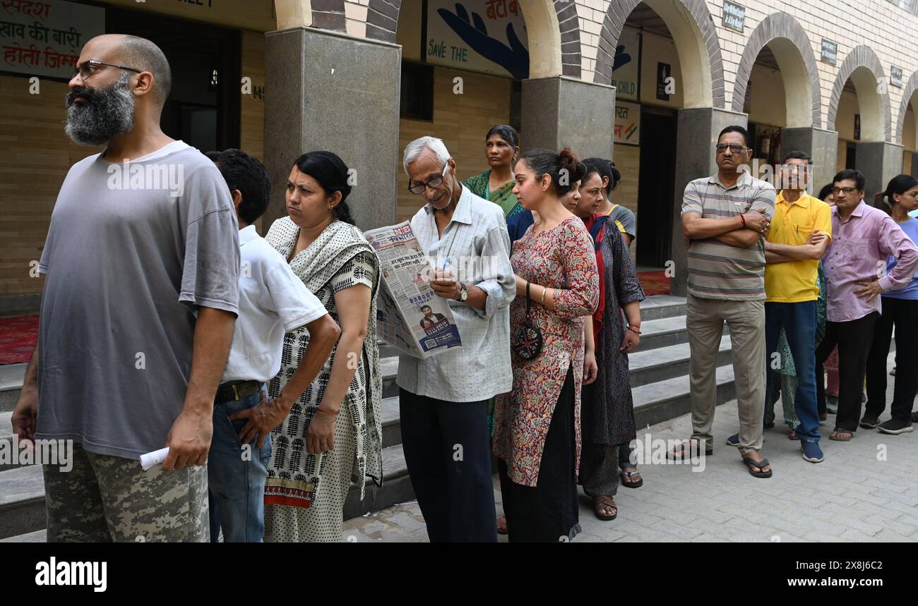 NEW DELHI, INDIA - MAY 25: Voters stand in queue to cast their votes at ...