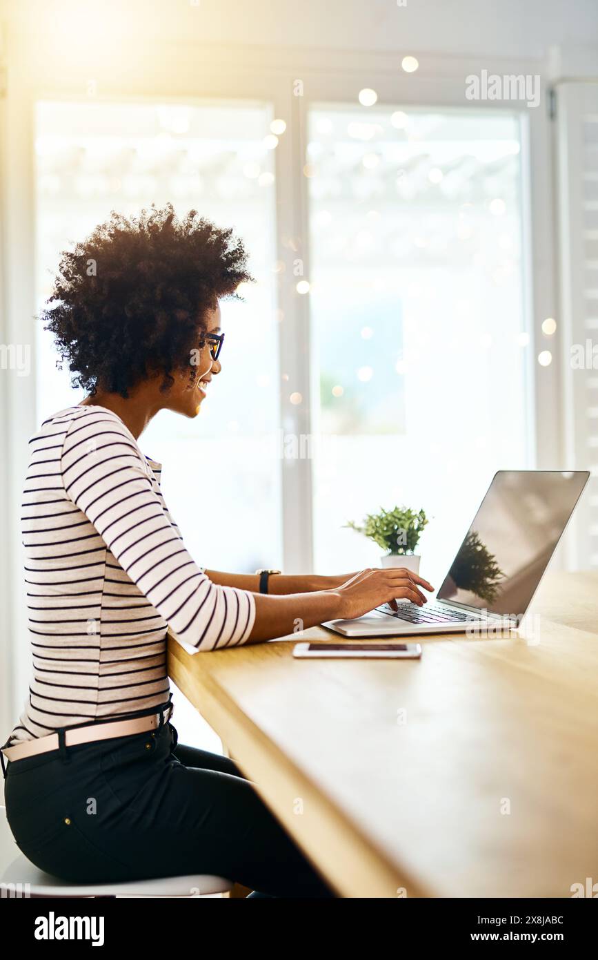 Remote work, laptop and black woman with glasses, typing and ...