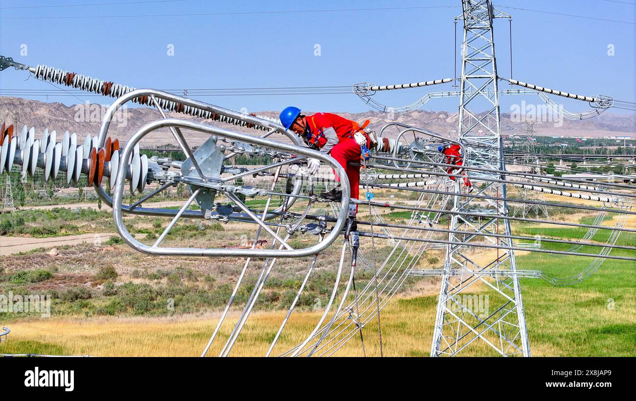KORLA, CHINA - MAY 23, 2024 - Construction workers erect a power grid ...