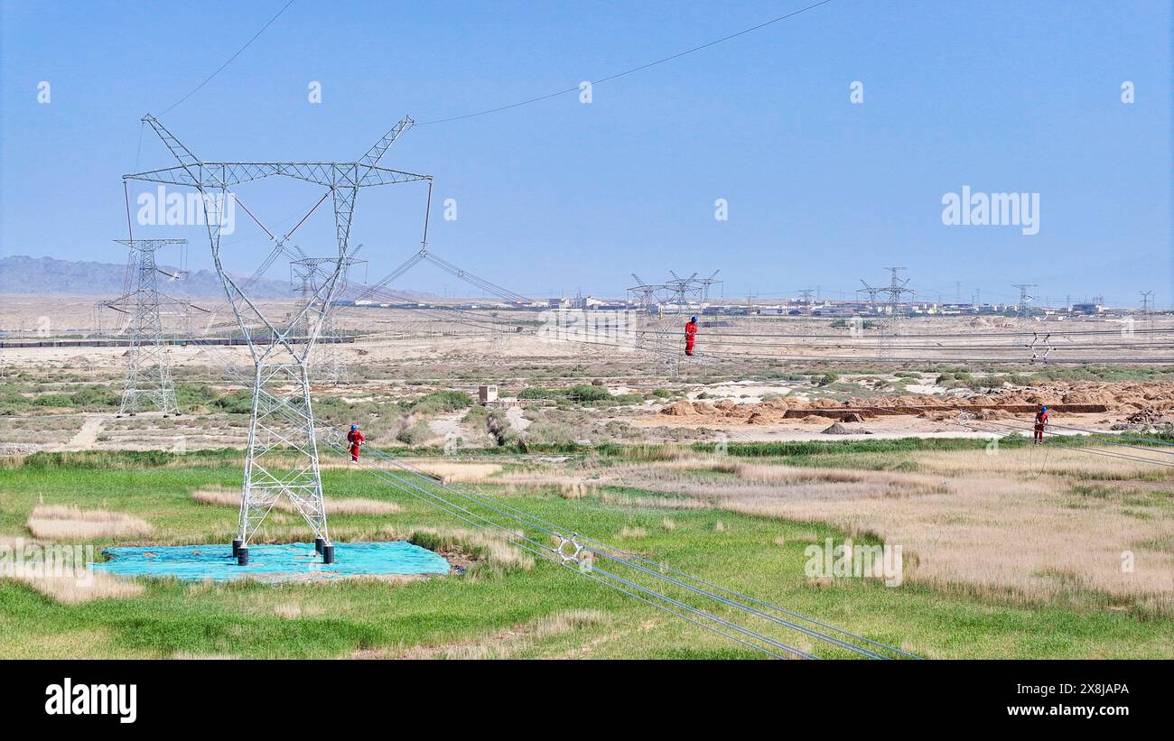 KORLA, CHINA - MAY 23, 2024 - Construction workers erect a power grid ...