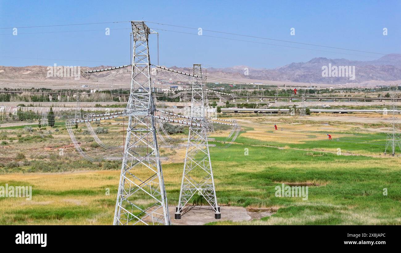 KORLA, CHINA - MAY 23, 2024 - Construction workers erect a power grid ...