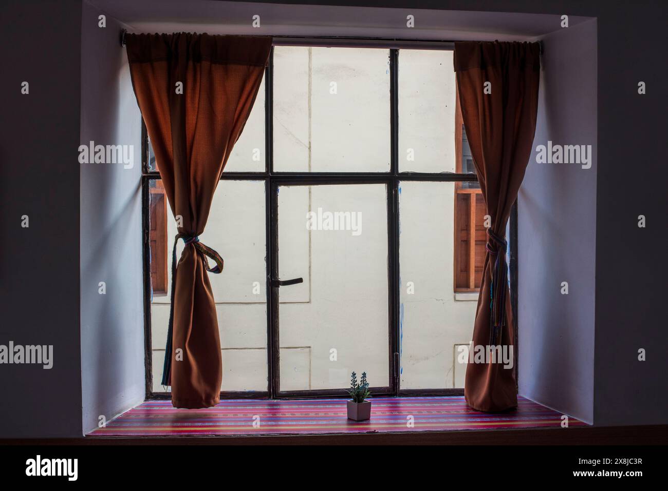 window with orange curtains in Cusco in Peru in South America Stock ...