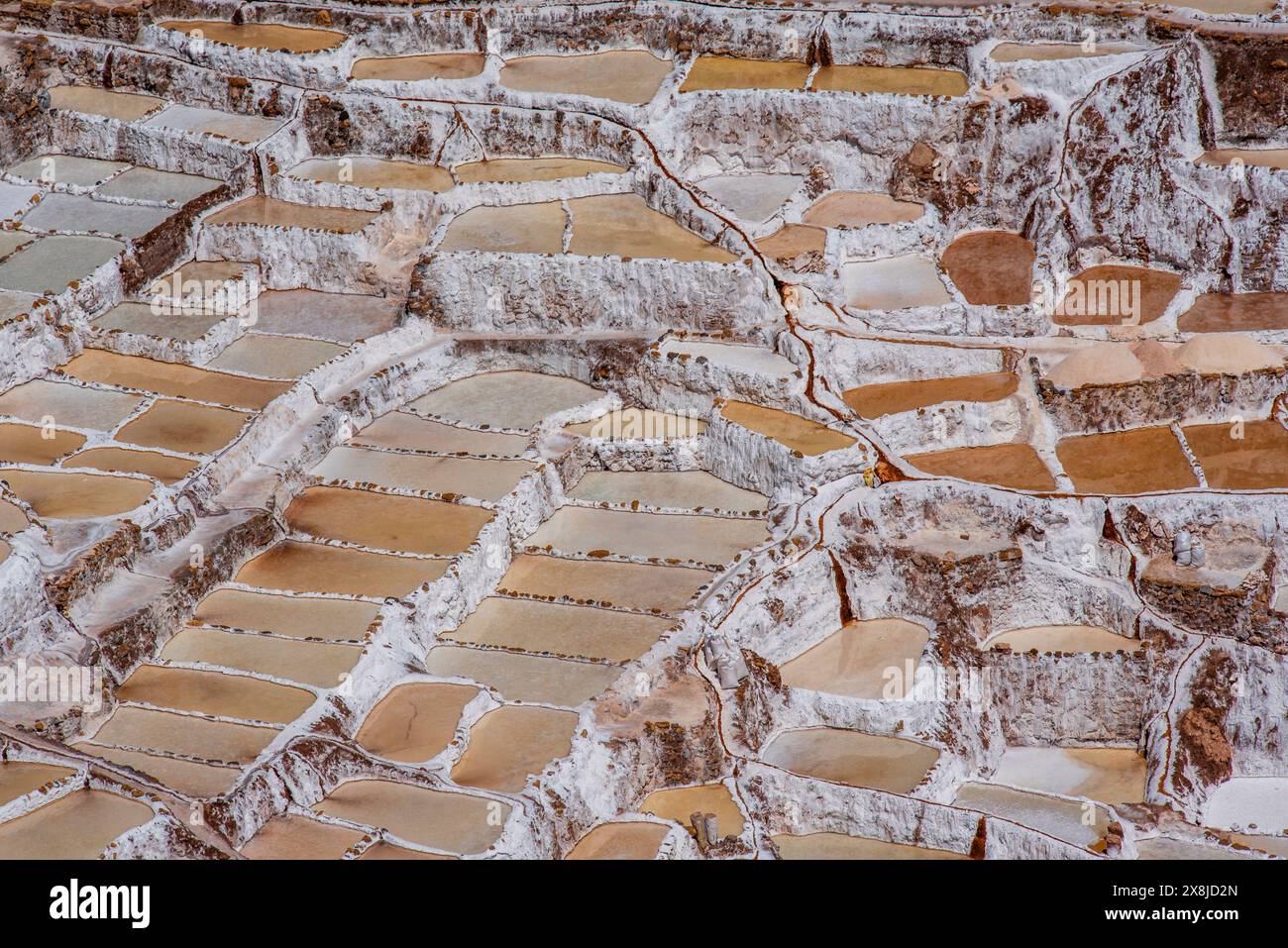 detail of the mountain salt pans with the white of the salt and the ...
