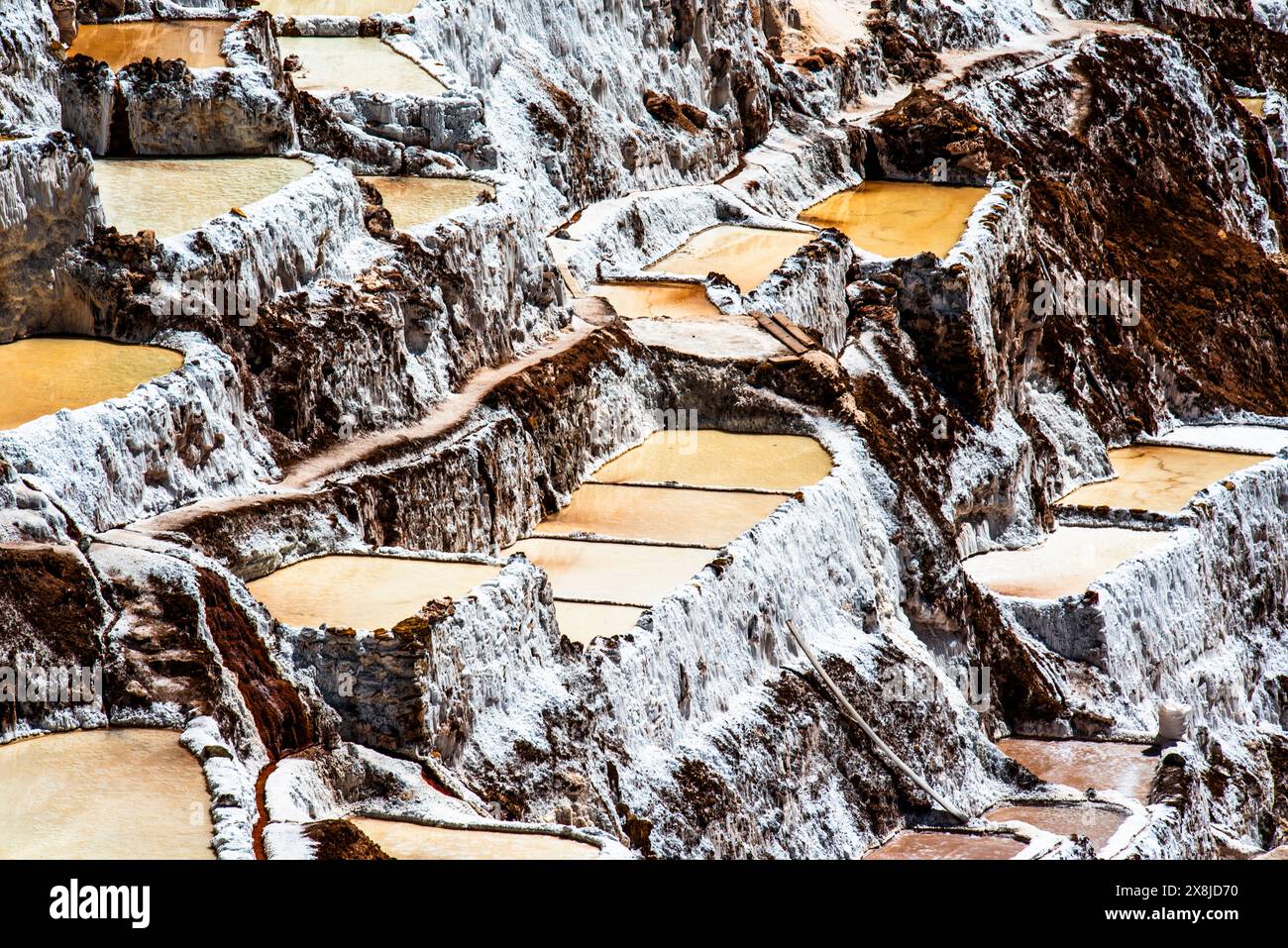 detail of the mountain salt pans with the white of the salt and the ...