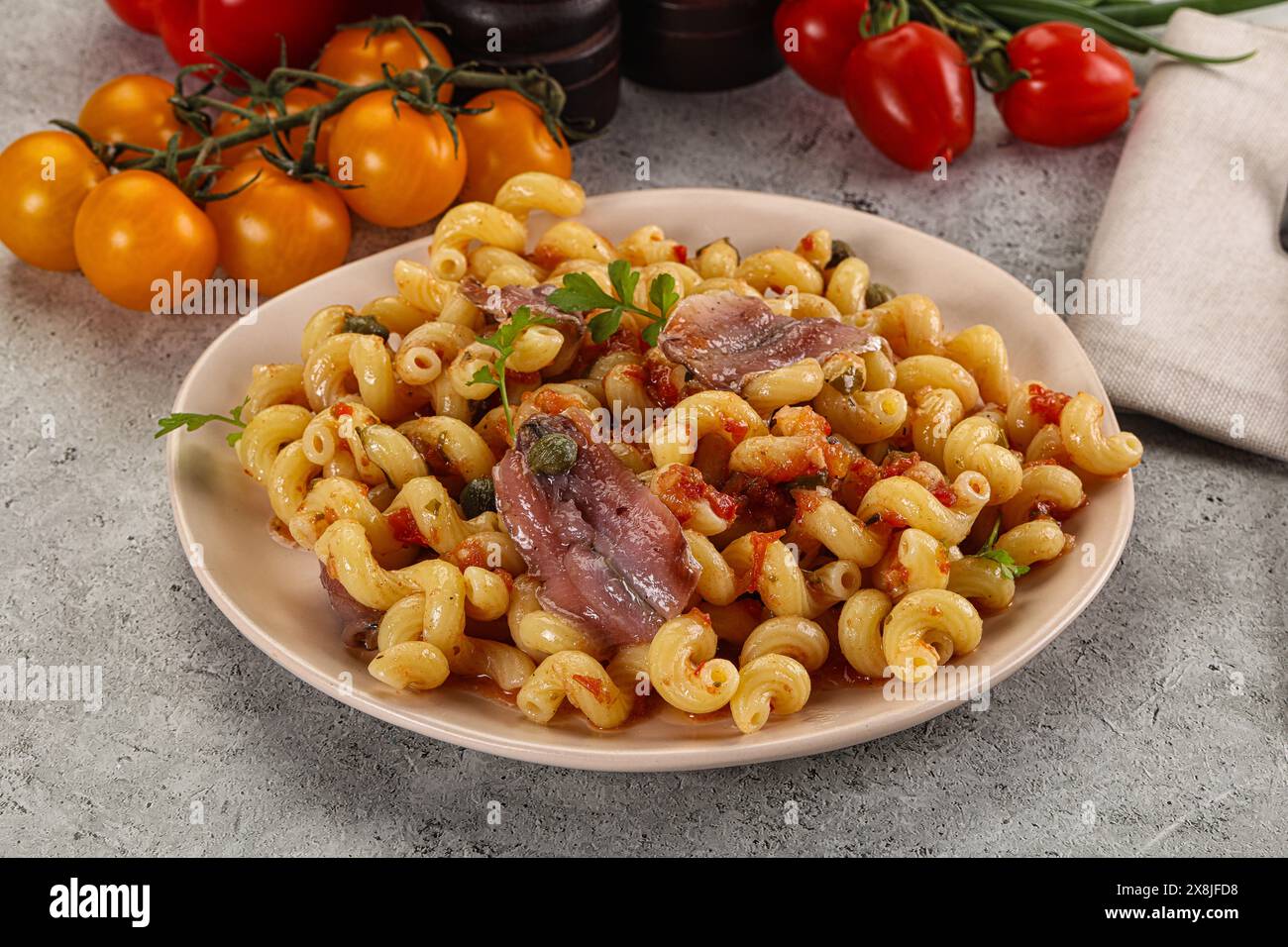 Italian pasta cellentani with anchovy and tomato sauce Stock Photo - Alamy